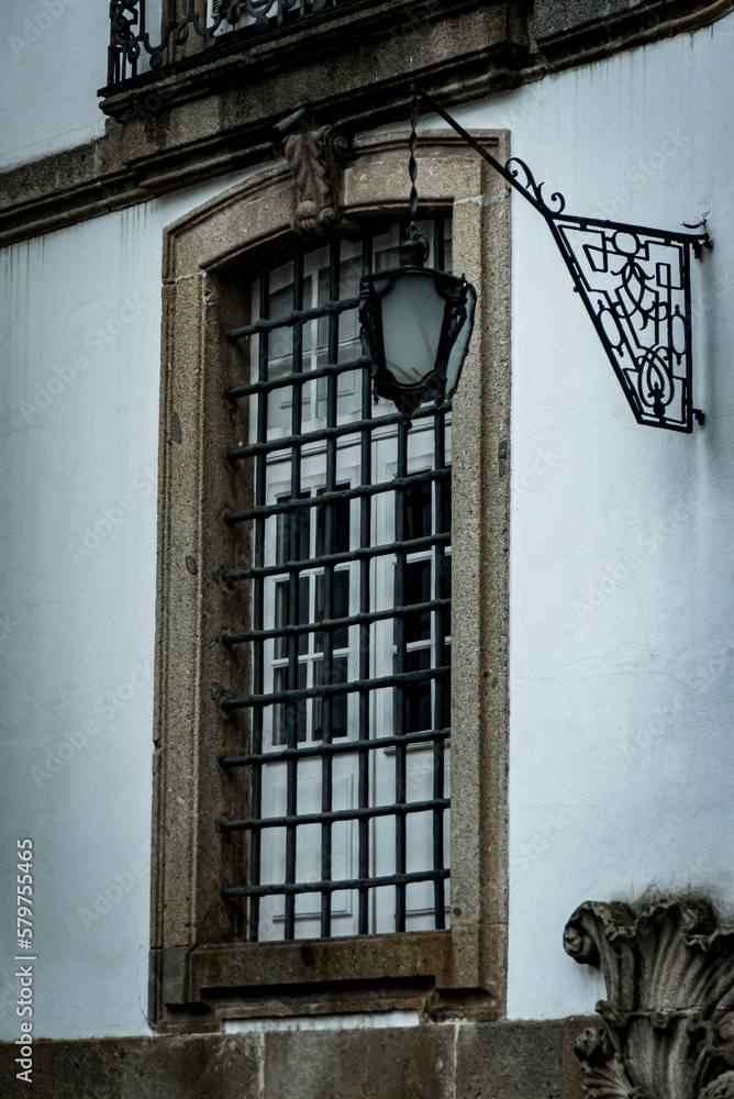 Lamp details on barred window of old building in Braga, Portugal Stock ...