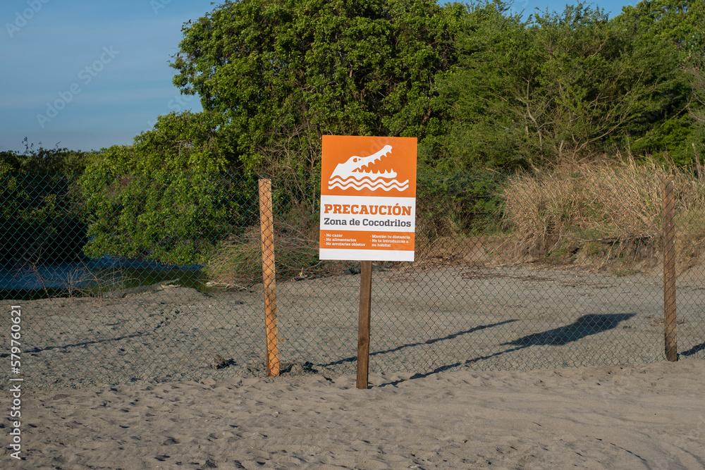 Sign in Spanish Caution crocodile area. No hunting, do not feed, do not ...