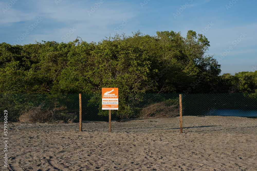 Sign in Spanish Caution crocodile area. No hunting, do not feed, do not ...