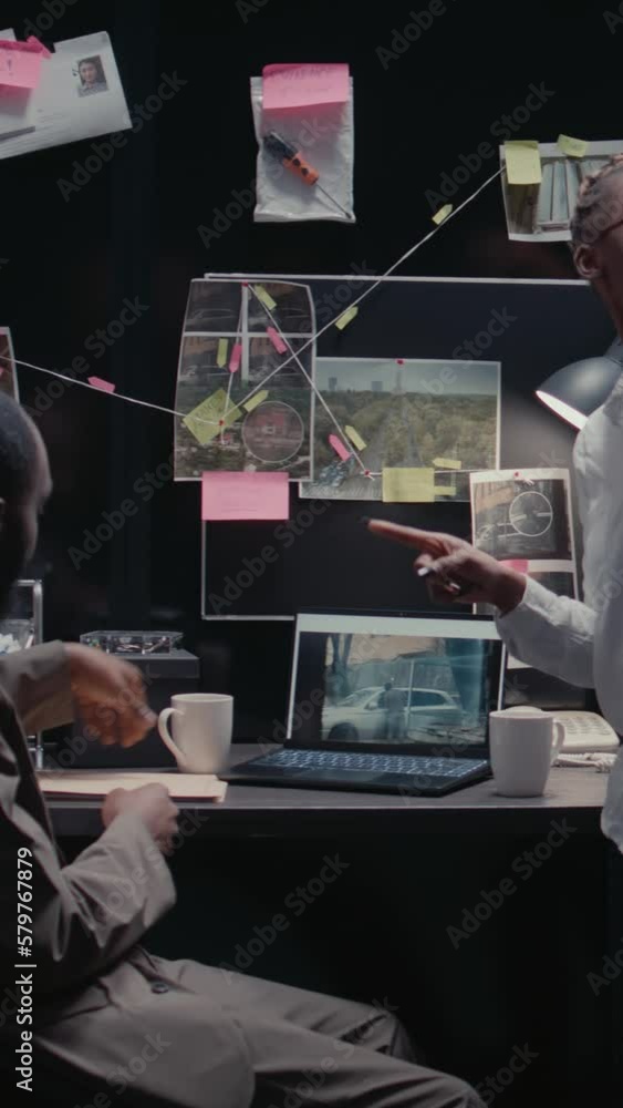 Vertical video: Police agents doing background checks for investigation ...