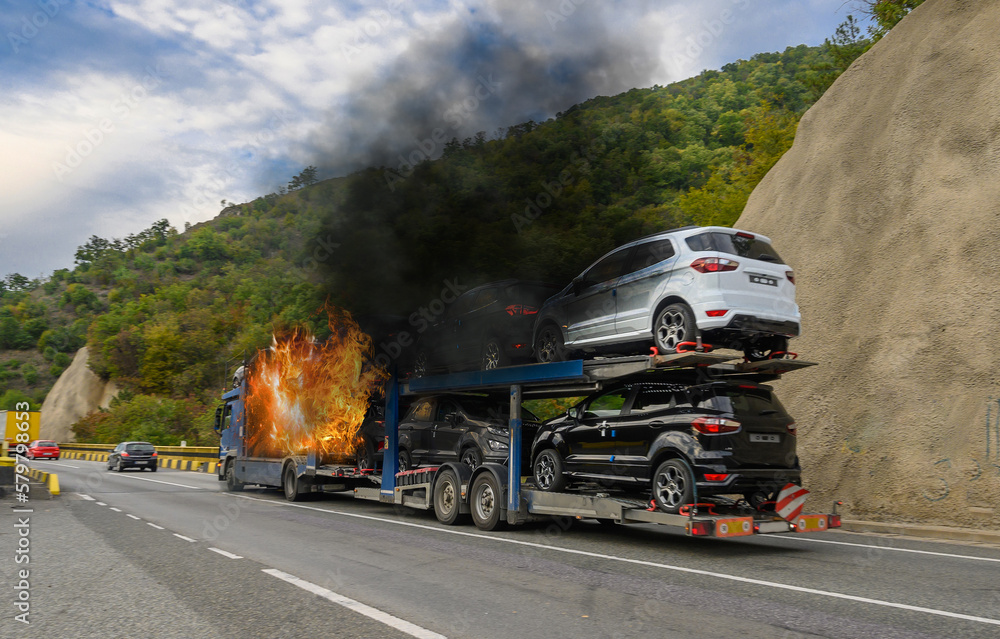 The truck transporting cars caught fire on the way. Fire caused by an ...