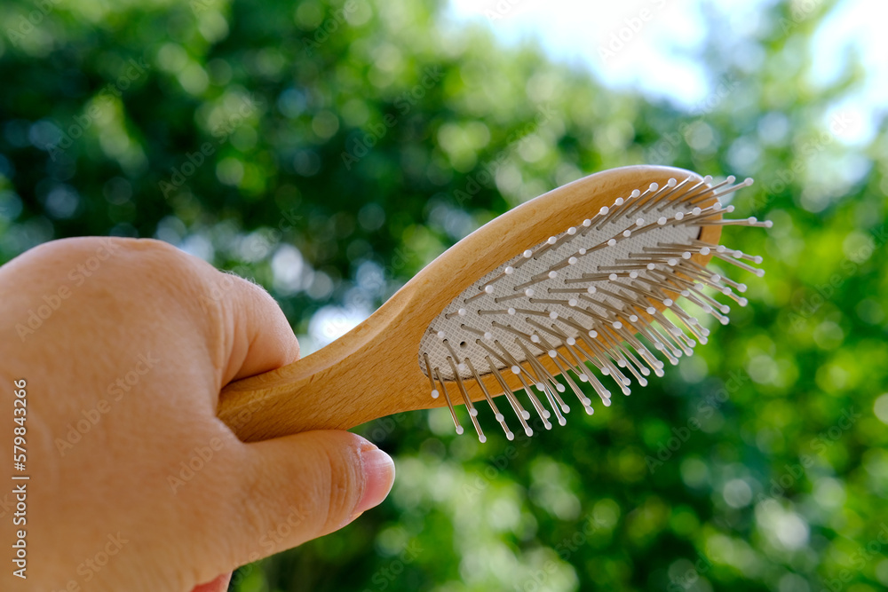 small wooden white comb, brush with metal teeth of longitudinal and ...