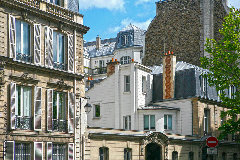 Paris street with ancient stone buildings with arched windows, white ...