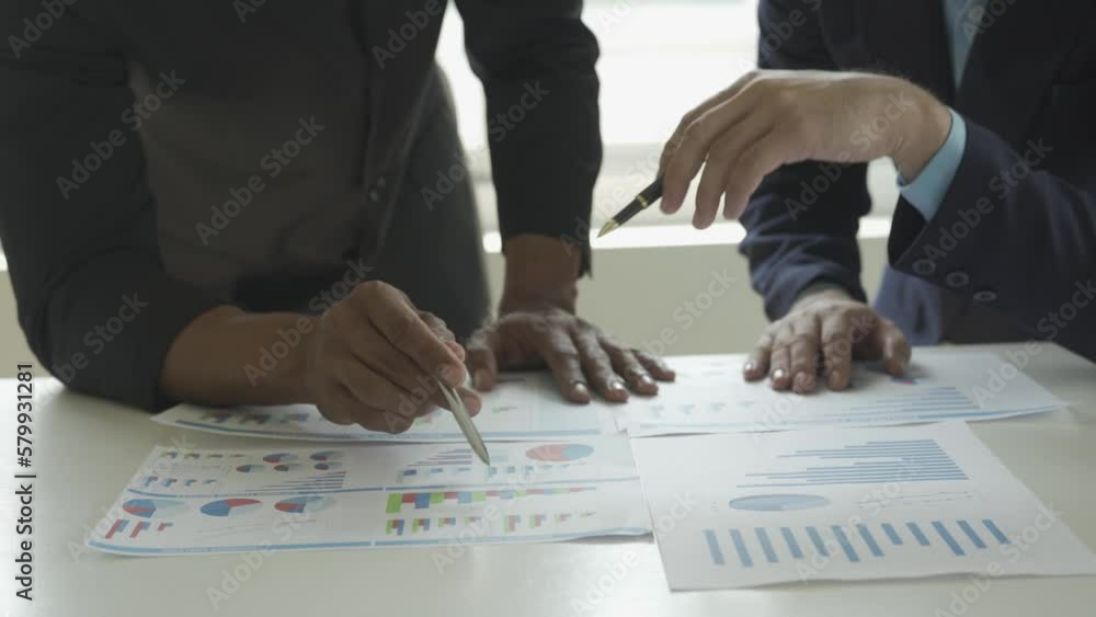 Two smart caucasian businessmen are talking and discussing financial ...