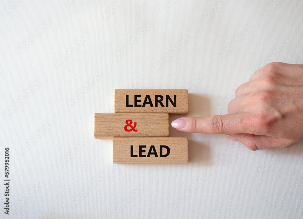 Learn and lead symbol. Concept words Learn and lead on wooden blocks ...