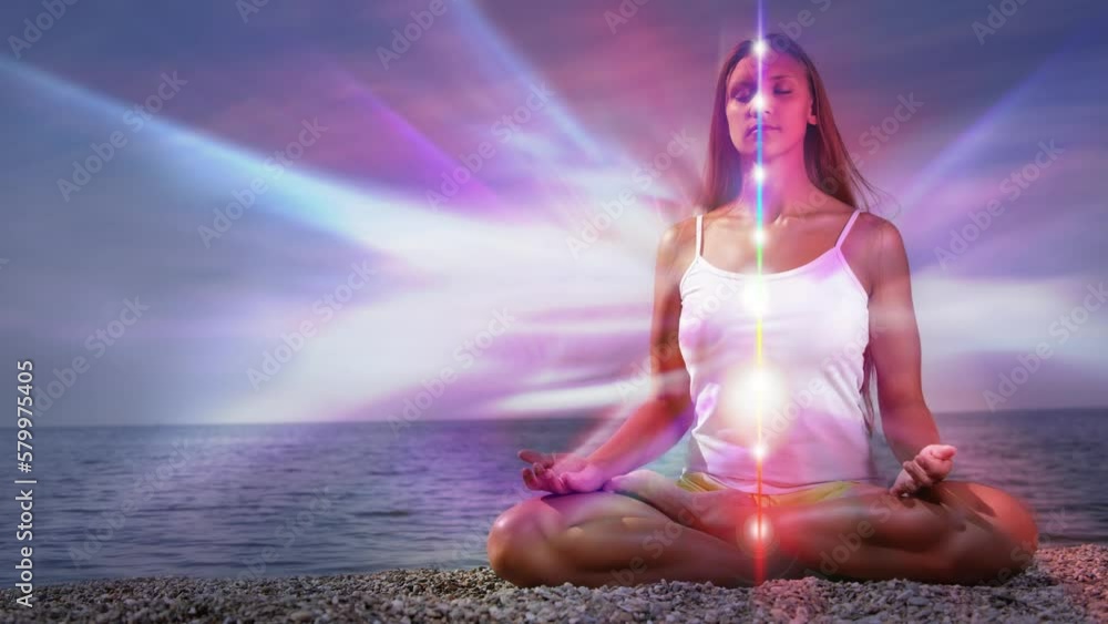 woman in lotus pose on beach with Glowing seven chakra. Kundalini ...
