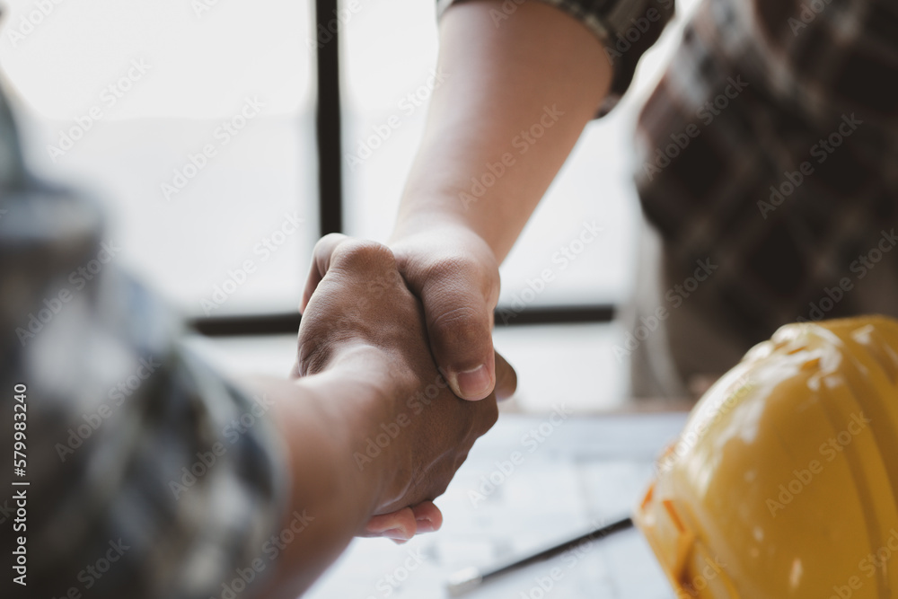 Team engineers and architects shake hands with the condo project owners ...