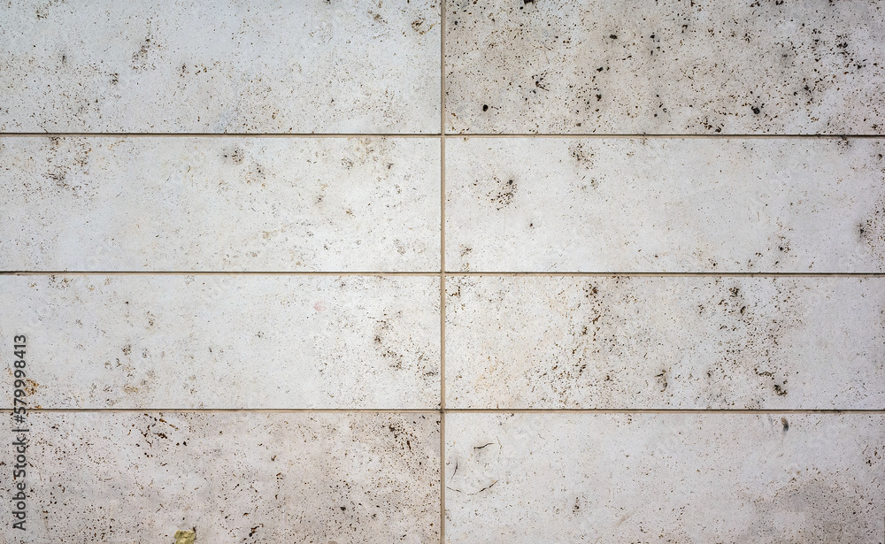 texture of a tiled beige stone wall as background, natural stone wall ...