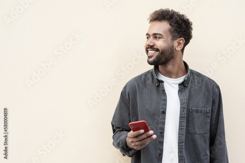 Young handsome man using smartphone in a city. Smiling student men ...
