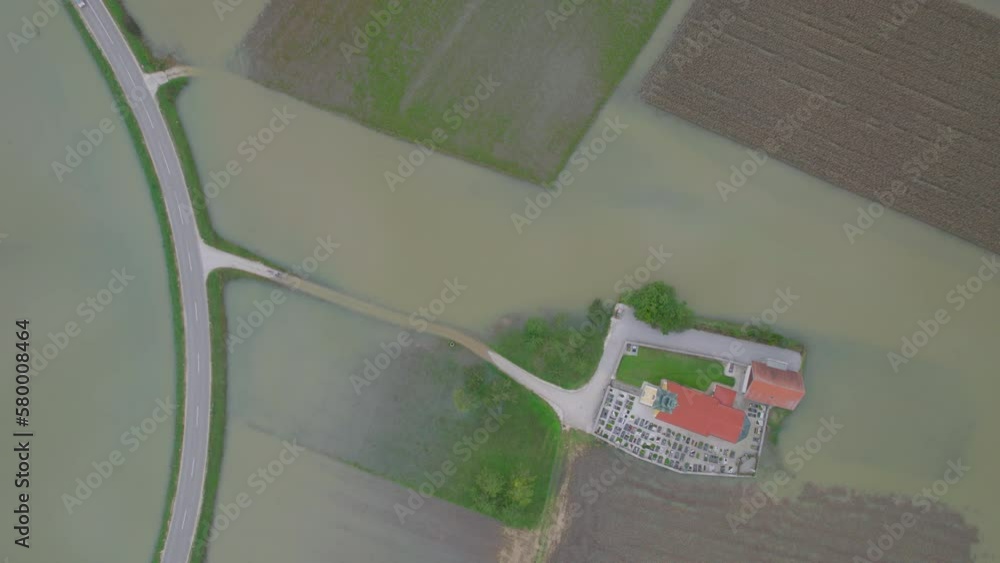 AERIAL TOP DOWN: Church with cemetery is inaccessible due to flooded ...