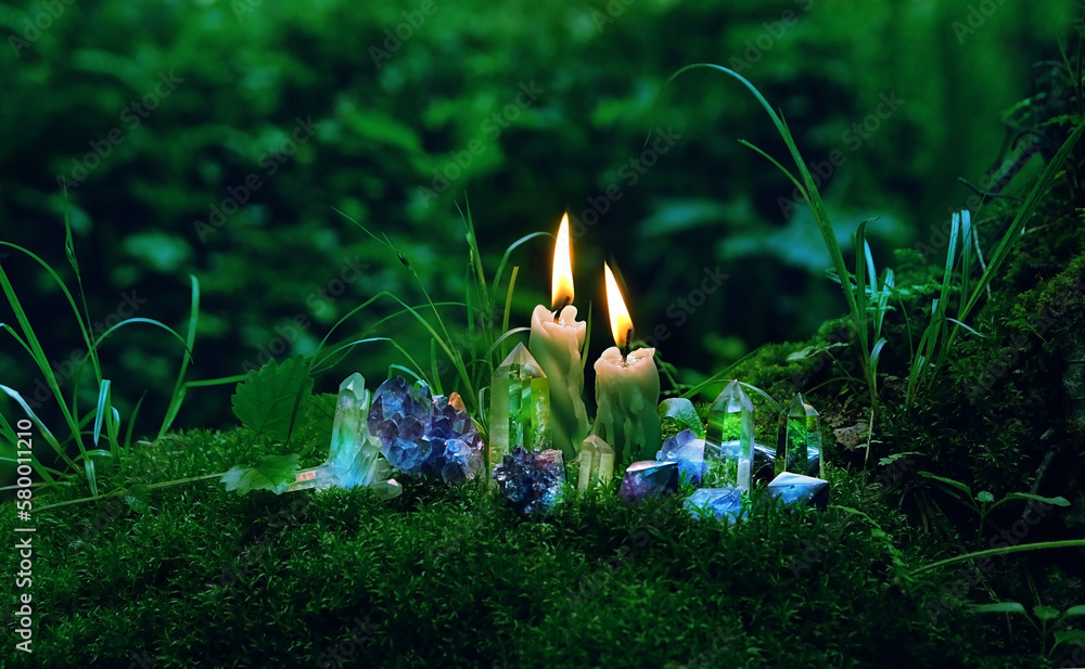 Foto de Minerals and candles close up in mysterious forest, dark ...
