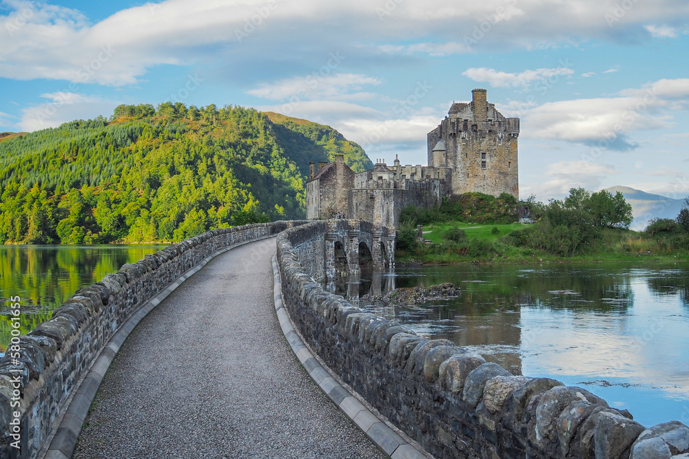 Stone bridge of Eilean Donan castle in early morning. Medieval Scottish ...