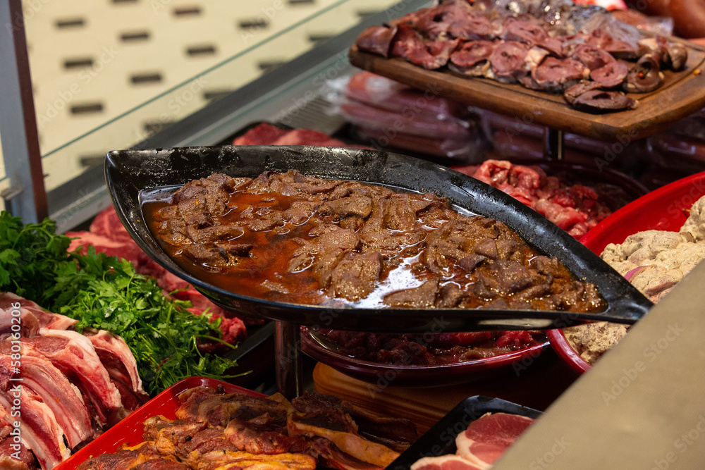 Meat department, showcase with variety of meat in different cuts ...