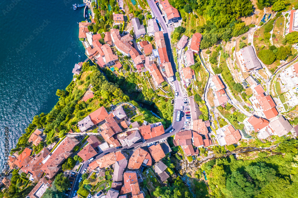Town of Nesso on steep cliffs and creek waterfall gorge on Como Lake ...