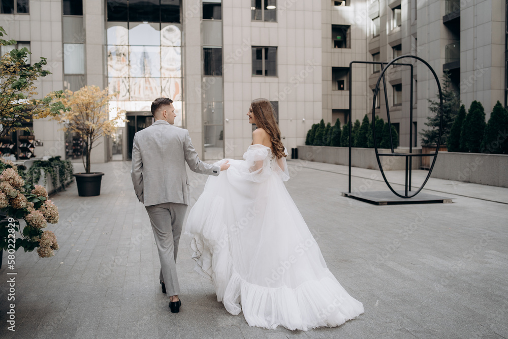 Back view of beloved couple getting married, having wedding phtoshoot ...