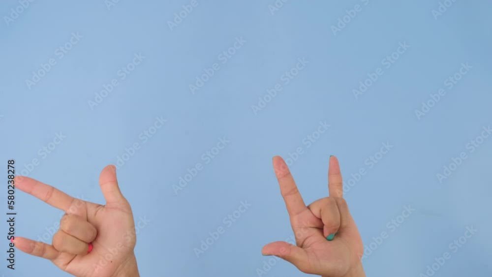 Female hand showing I Love You sign isolated on pastel blue background ...