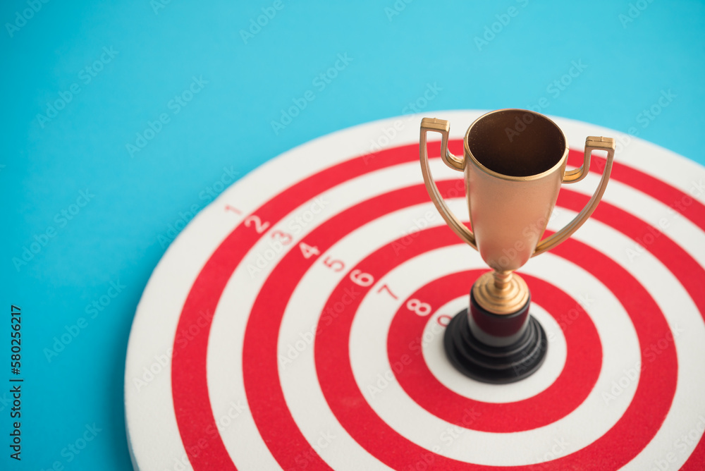 Gold winner trophy on center target copy space. Successful and achieve ...
