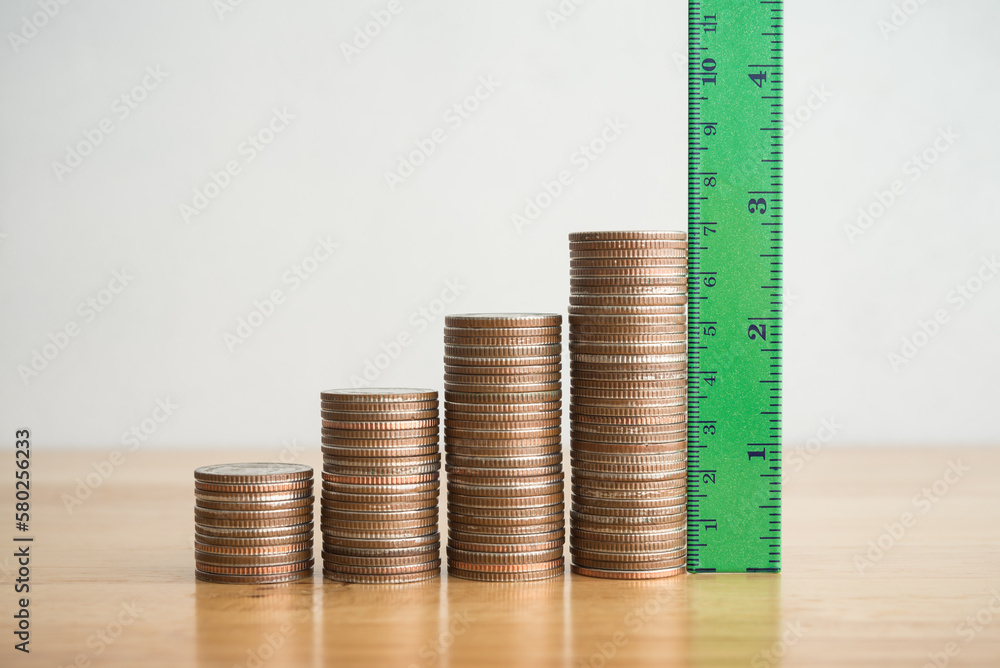 Fotka „Green measuring ruler measure growth stack coins on wooden table ...