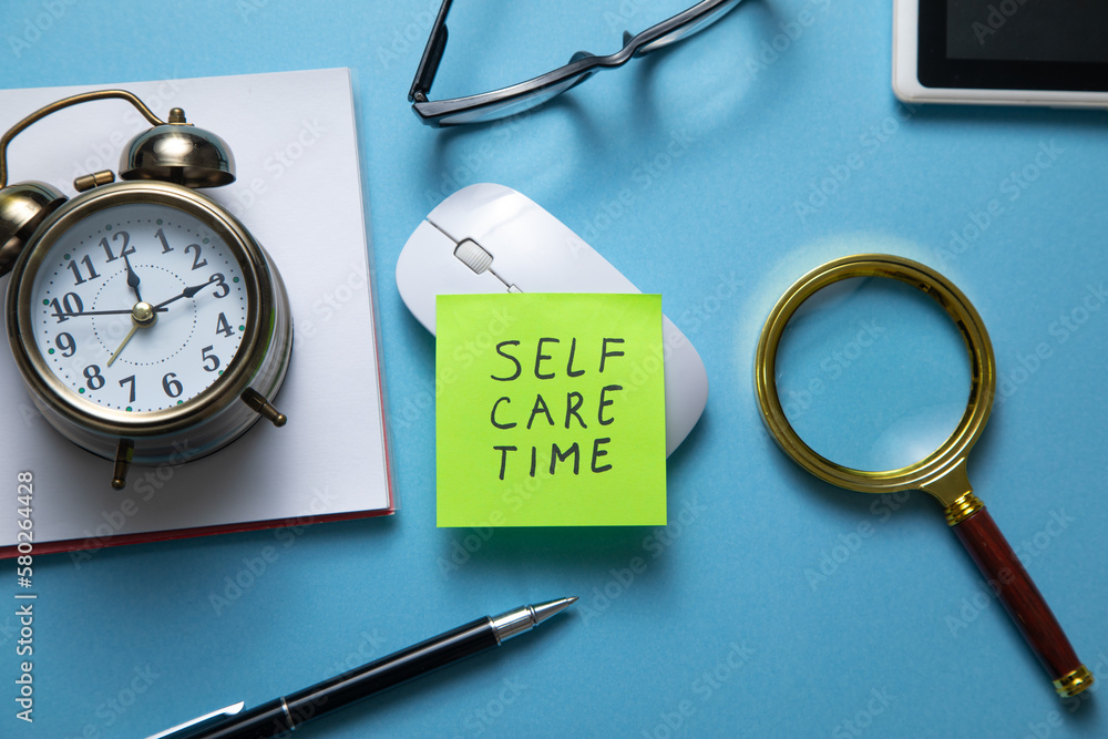 Self care time on sticky note with a clock and business objects. Stock ...