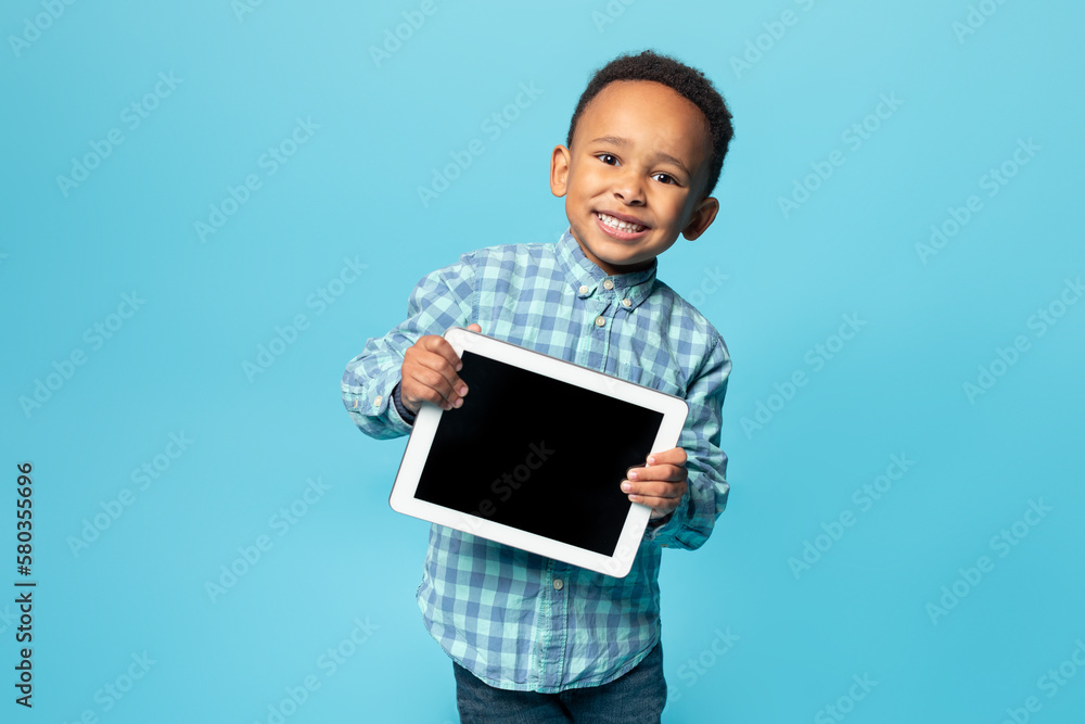 Apps and distance learning for kids. Happy african american boy showing ...