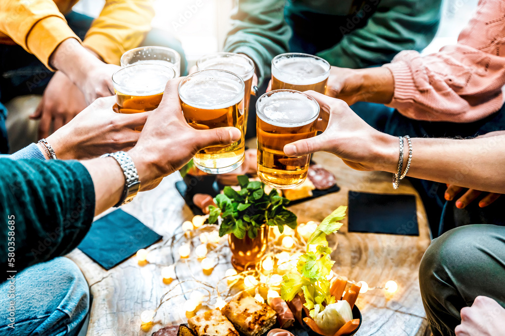 Fotografia do Stock: Friends cheering beer glasses on wooden table at ...