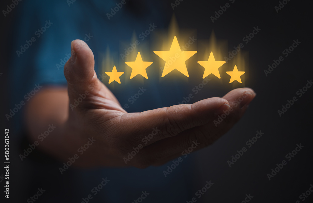 hand of customer or client holding the stars to complete five stars ...