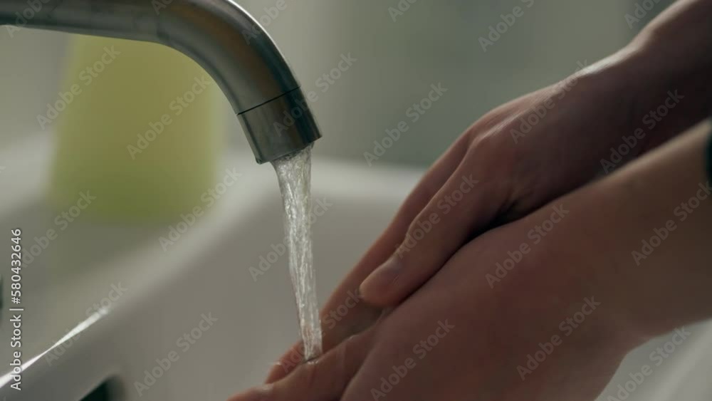 She washes her hands with soap in the bathroom, the woman knows the ...