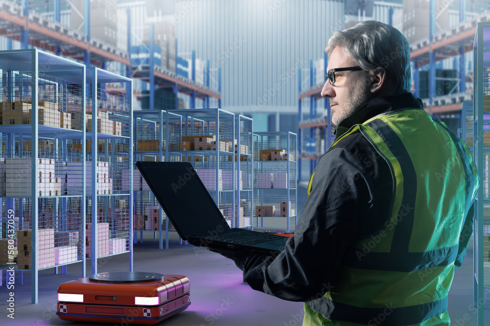 Warehouse engineer. Man who manages robot. Robotization of production ...