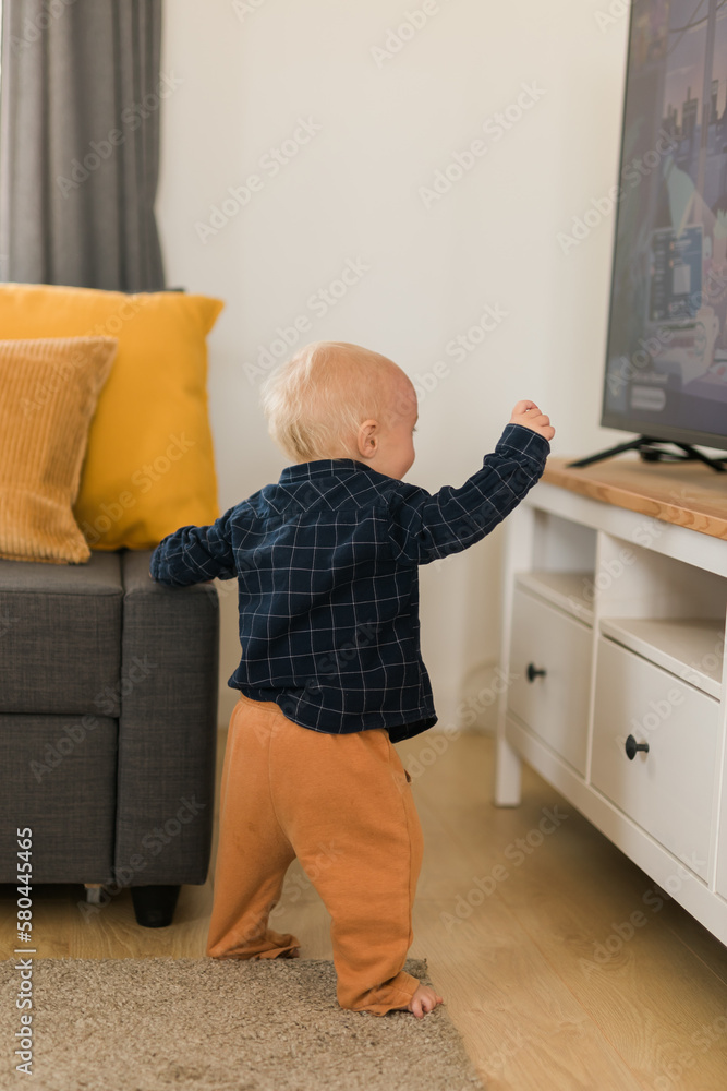 Caucasian baby newborn infant making first steps. Cute toddler kid ...