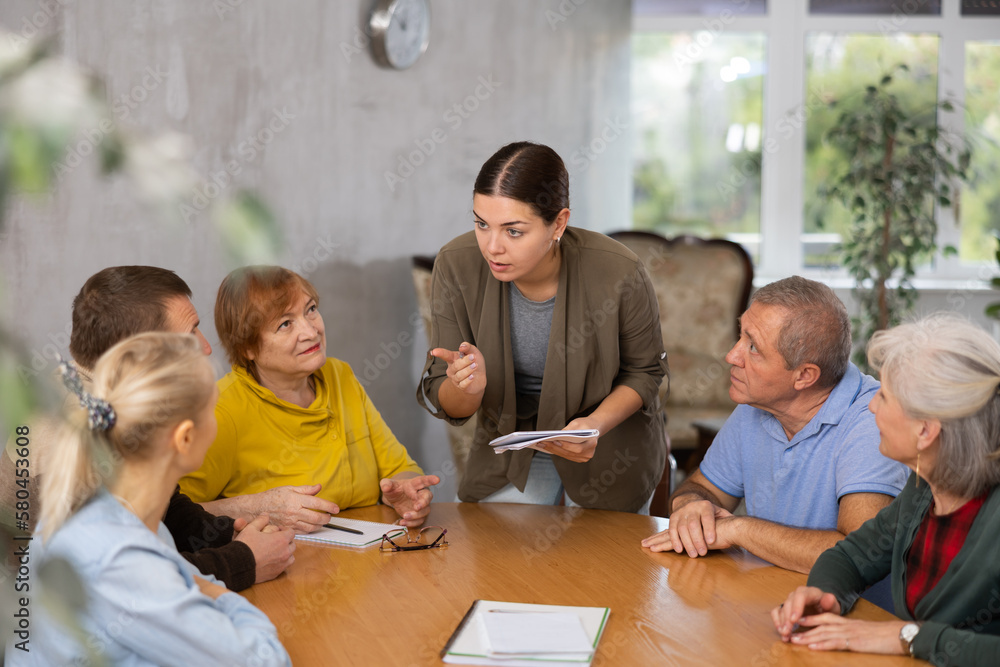 Group of elderly people communicating in English-speaking club with ...