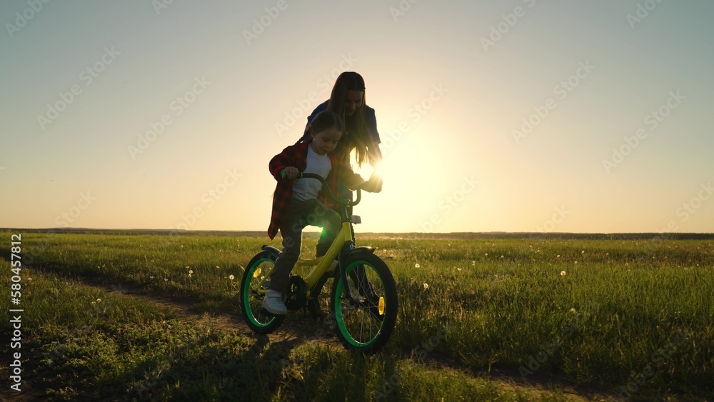 Childhood dream to ride bike. Mom teaches her little daughter to ride ...