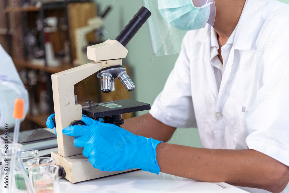 Indian Scientist man look into Microscope research in science ...