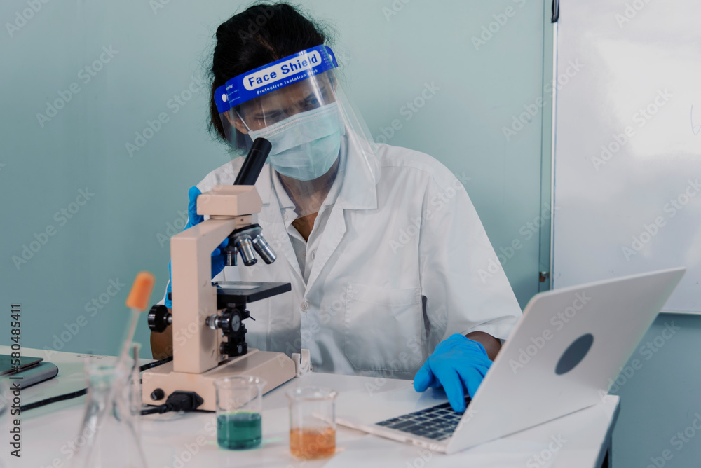Indian Scientist man looking Microscope using laptop analyze research ...