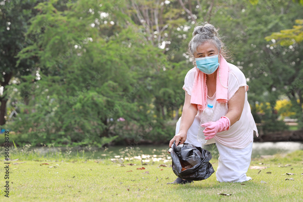 volunteer tourist asian senior old woman cleaning up garbage and ...