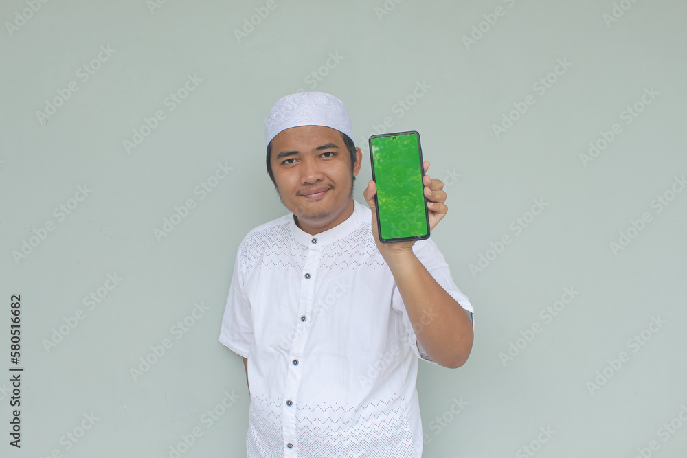 Smiling young Asian Muslim man give ok hand sign with confident ...