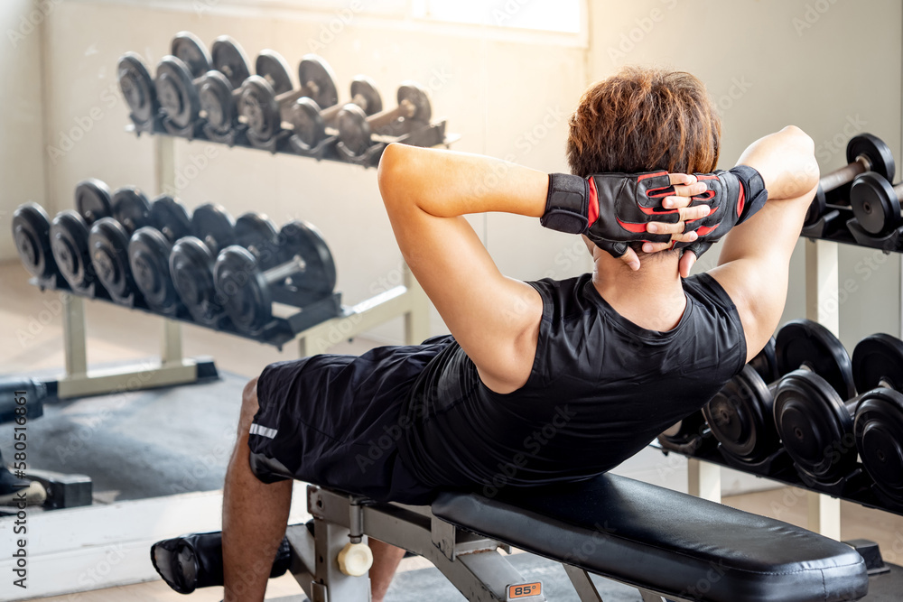 Asian Sport man with well trained body in black sportswear lying on ...
