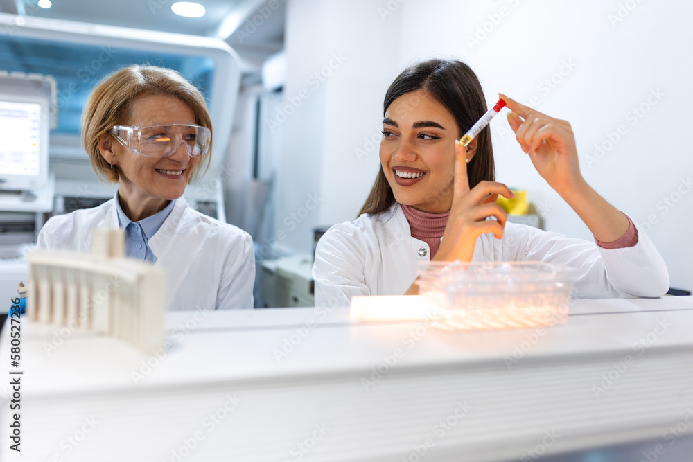 Close up of young doctor in biochemistry analysing and holding test ...