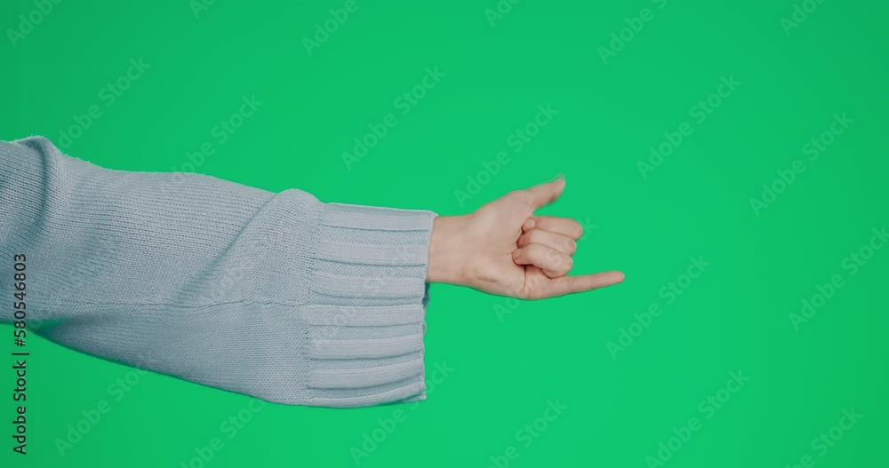 Hand, shaka and a woman on a green screen background in studio to ...