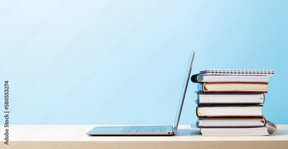 Laptop and stack of notepads Stock Photo | Adobe Stock