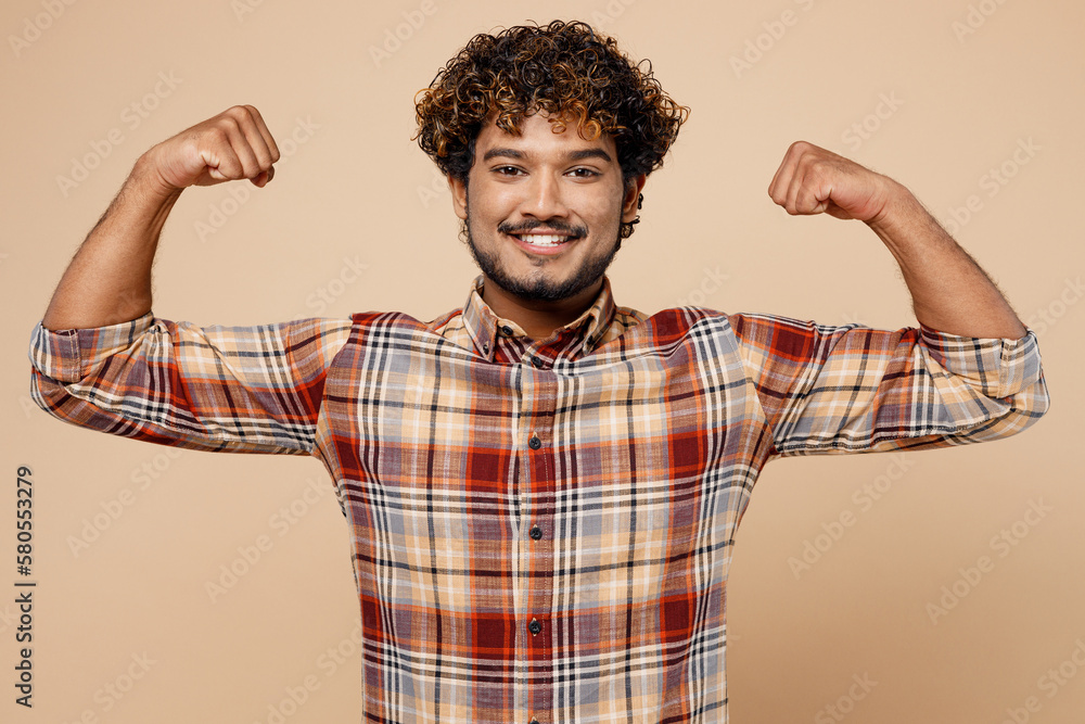 Strong sporty Indian man wear brown shirt casual clothes showing biceps ...