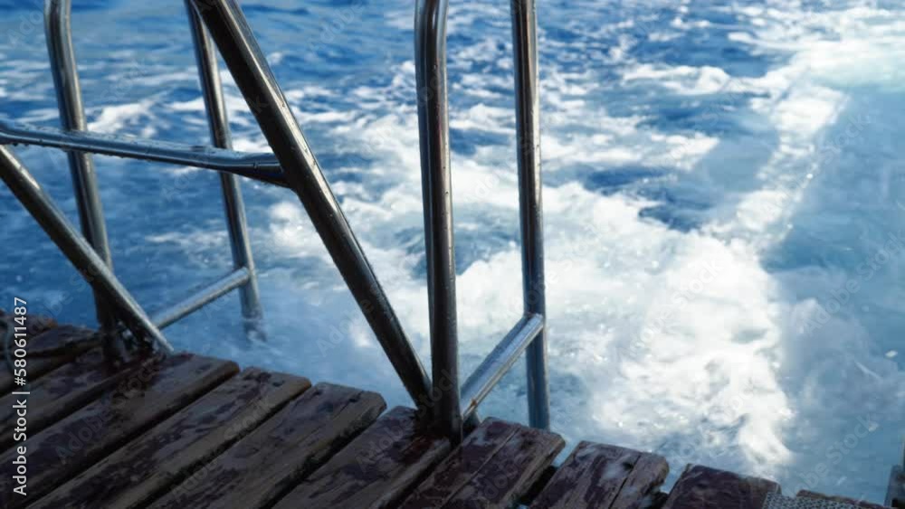 A view of the stern of the ship with steel handrails and a bridge ...