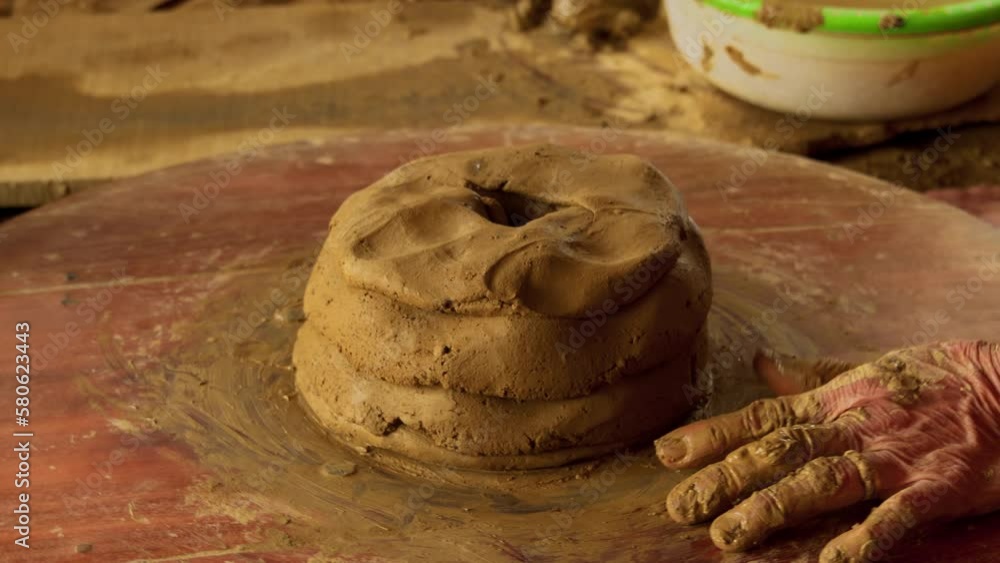 Close-up footage of traditional pottery making in Asia, showing an ...