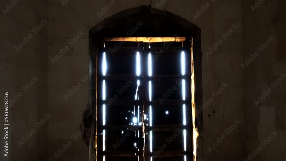 We see the main door of Zinciriye Madrasa and the light beams entering ...