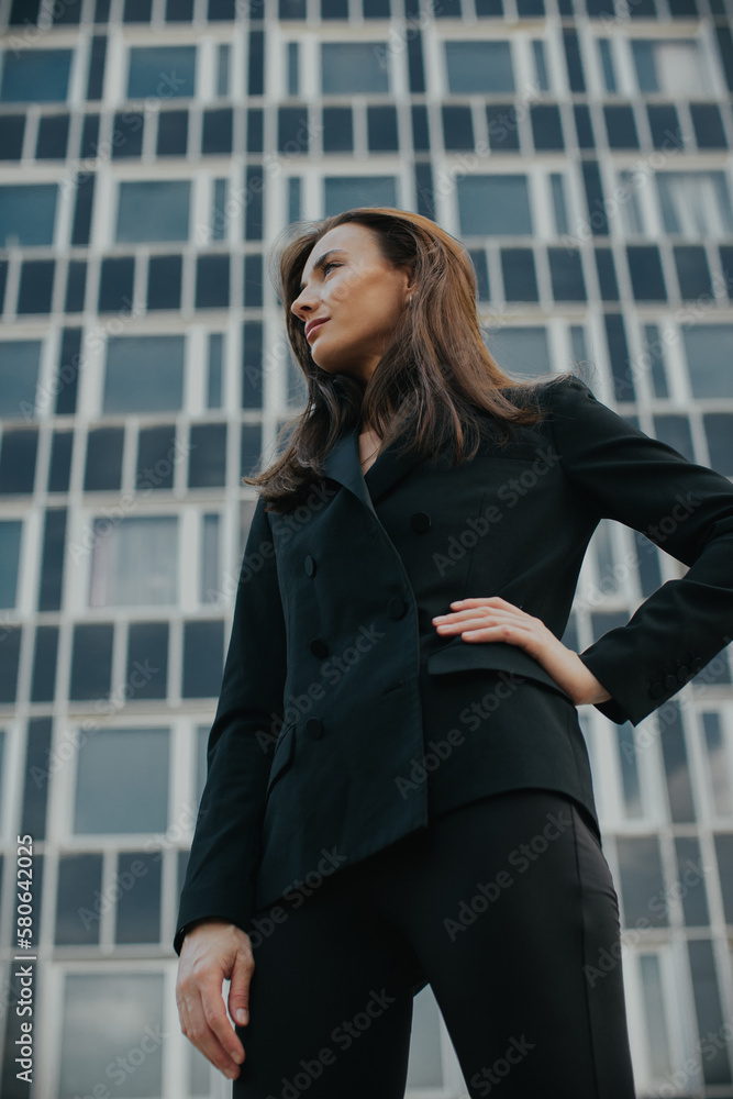 Fashion street style portrait of a beautiful girl in a black suit. A ...