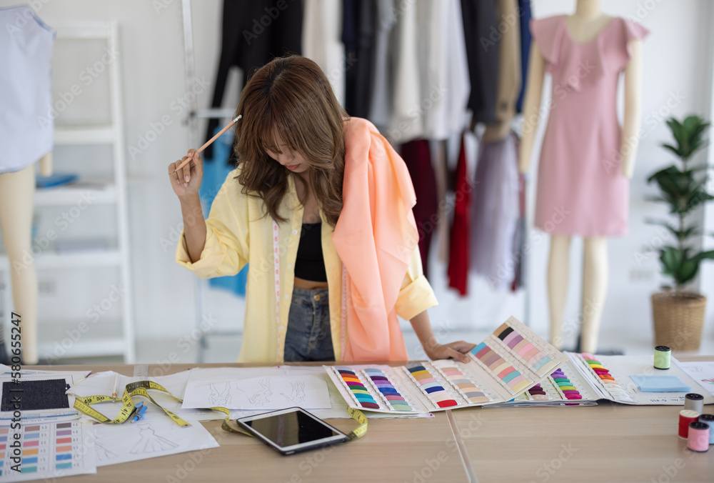 Foto de A female professional costume designer uses a pencil to draw ...