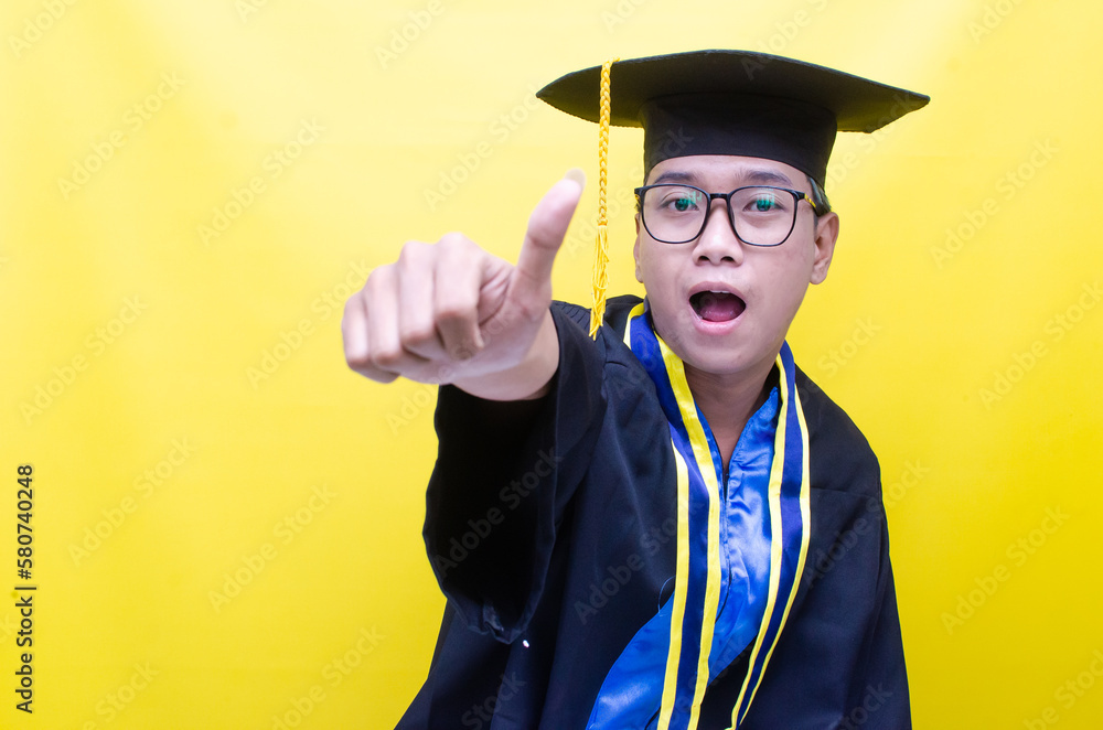 asian young man gives thumbs up and shouts happily to celebrate his ...