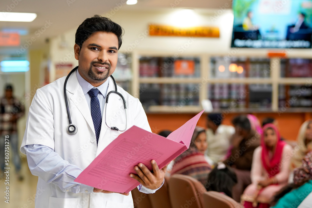 Young indian doctor watching medical report at hospital. Stock Photo ...