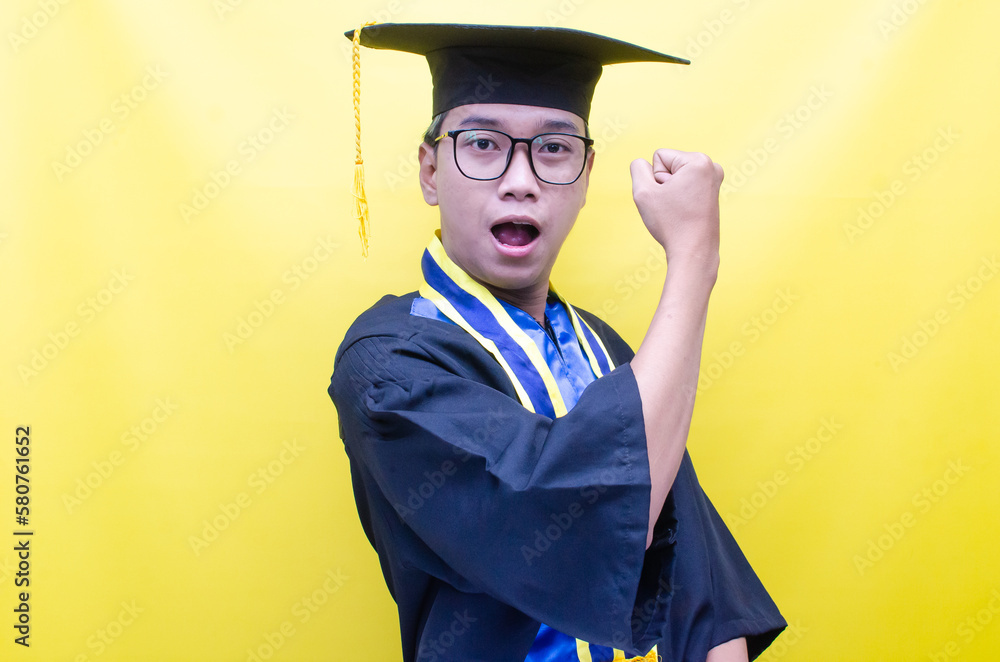 asian young man clenches his fist and shouts happily to celebrate his ...