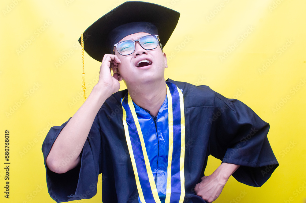 sad Asian man in graduation cap and gown rubbing his tears. student ...