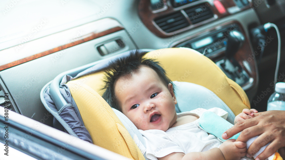 Blurred soft images, an Asian baby newborn girl lying on the car seat ...